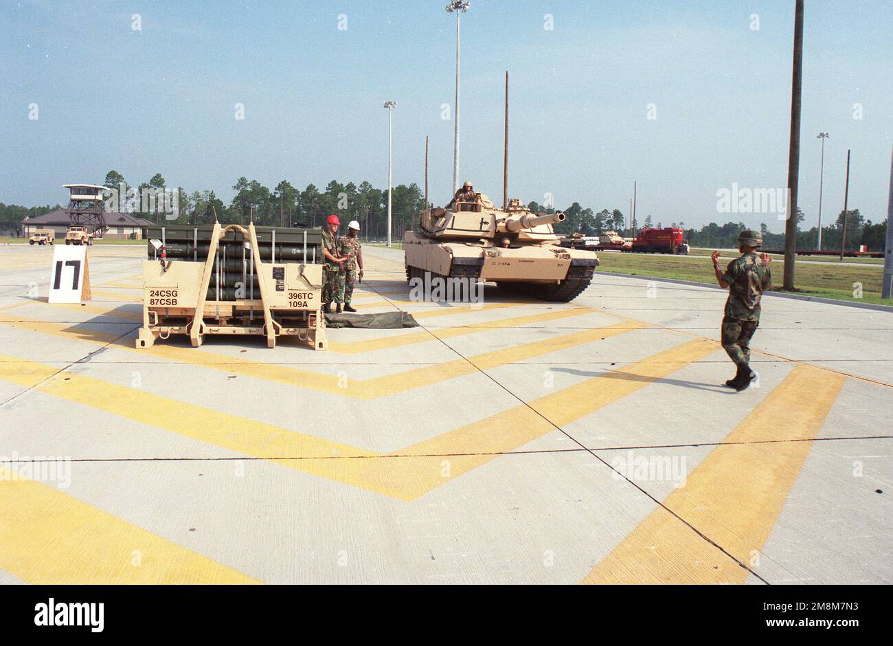 A member of the 3d Infantry Division directs an M1 Abrams tank onto the ...