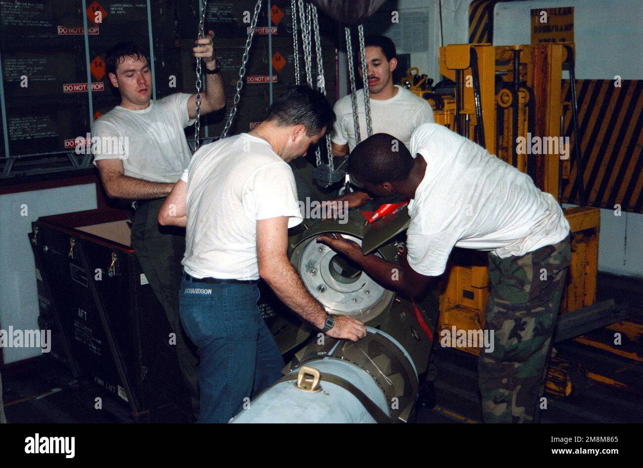 Aviation Ordnancemen hoist a Paveway III GBU-24/A laser guided bomb for ...