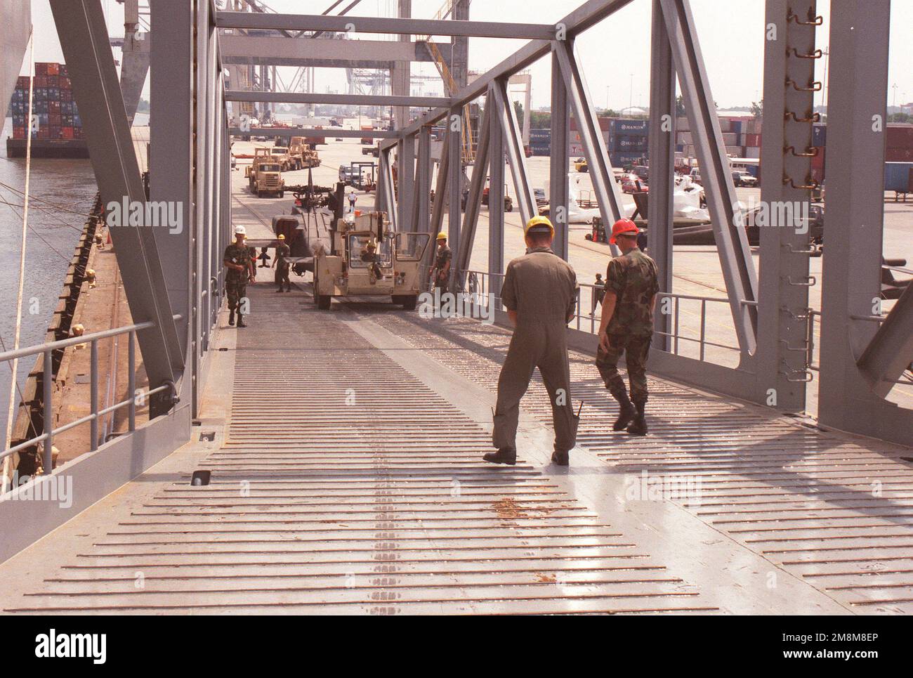A 3d Infantry Division (M) AH-64 helicopter is towed up a ramp for ...