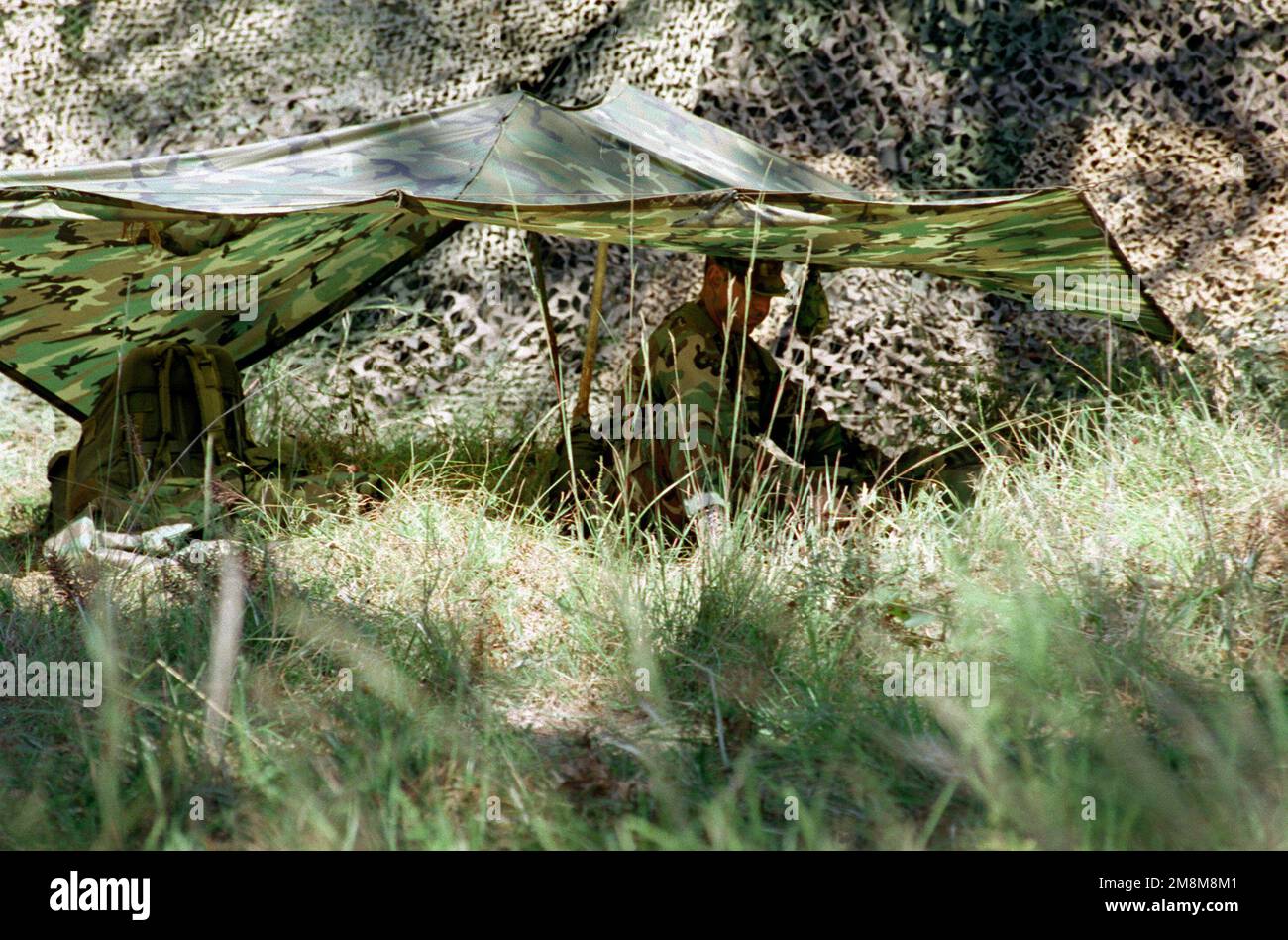 A soldier takes a "shade" break at the Joint Readiness Training Center ...