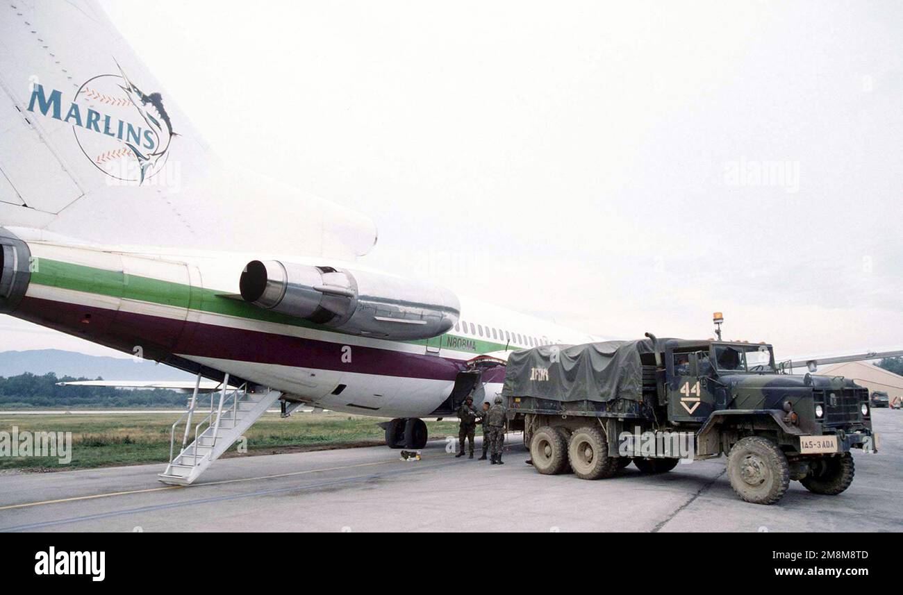 A Miami airliner is loaded with luggage by soldiers from the 1ST ...
