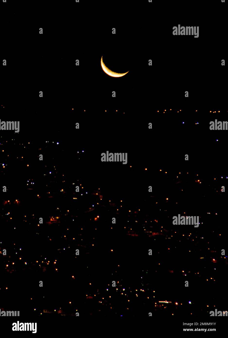 A mesmerizing view of a moon in the dark black sky at night in Chile ...