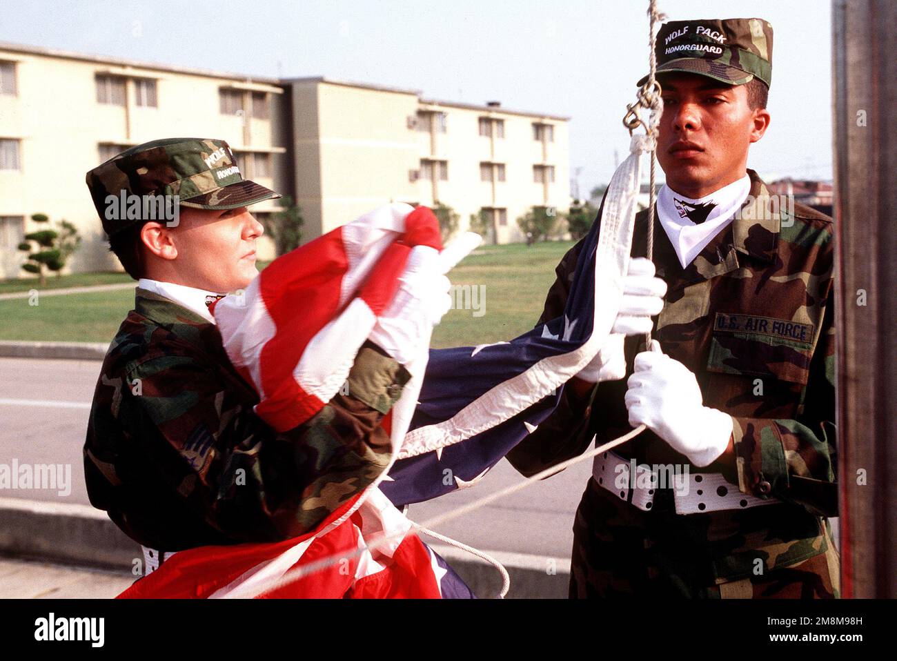 Members of the Wolf Pack Honor Guard fold the United States flag during ...