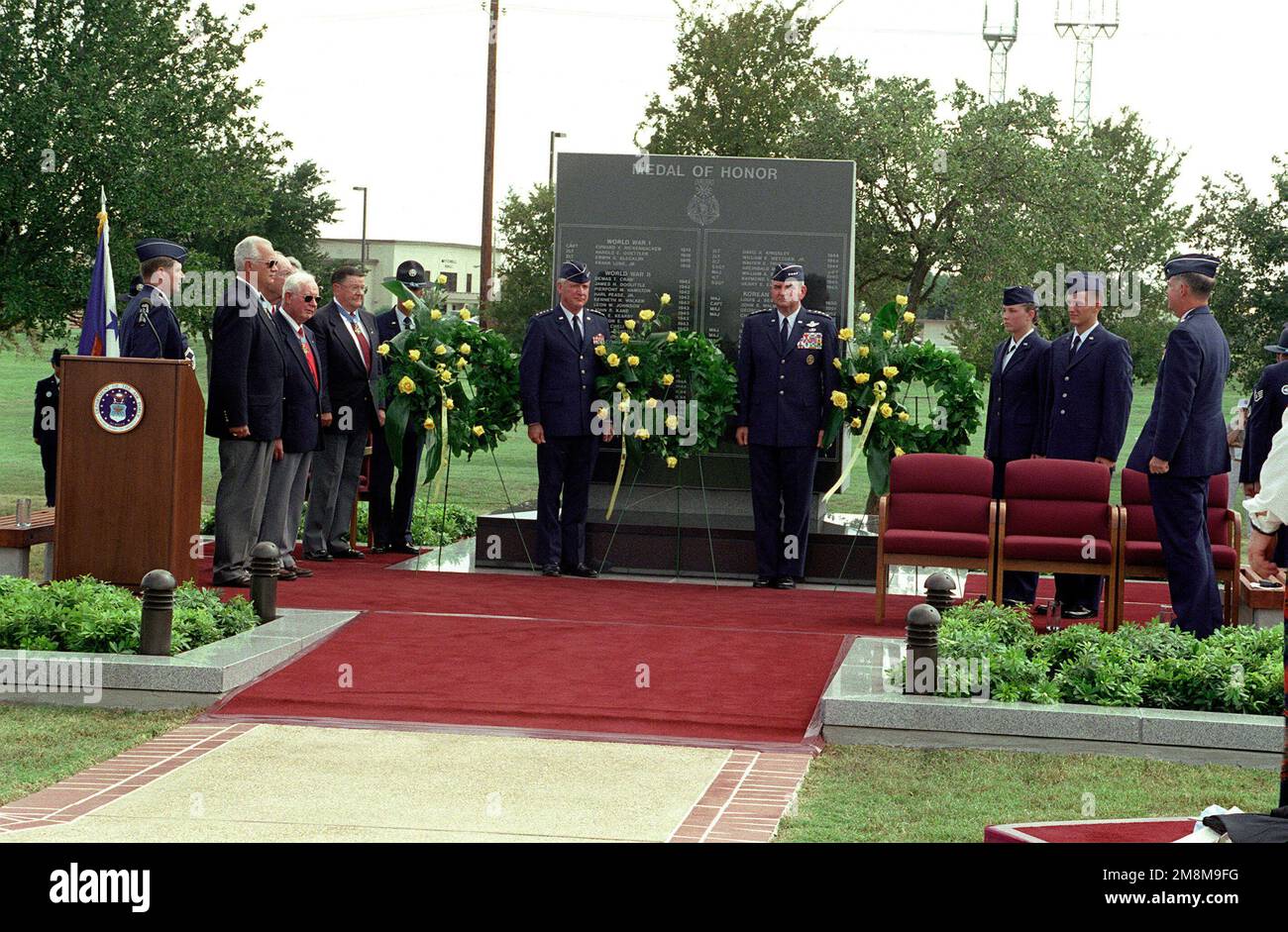 Officials stand at attention following the wreath laying ceremony at ...