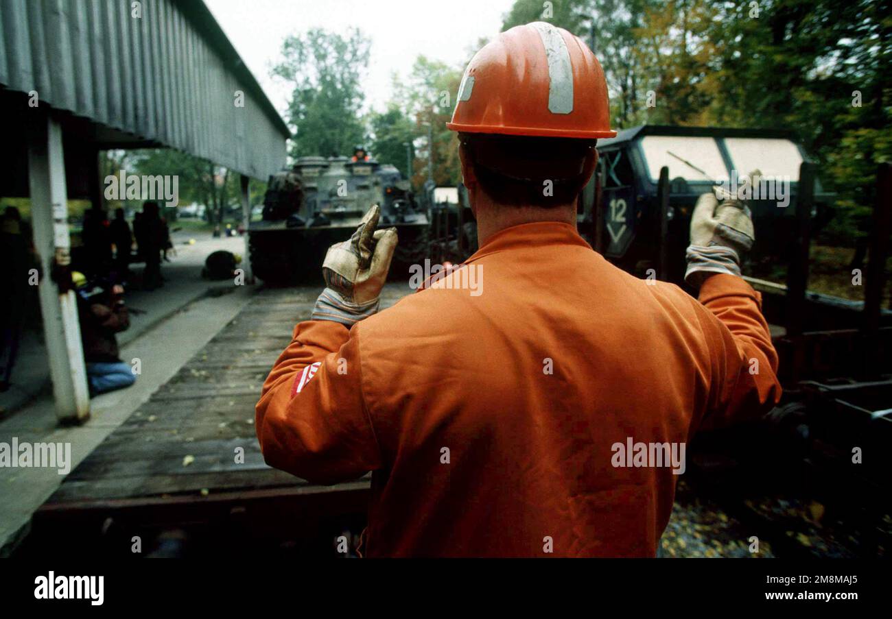 A German railroad worker helps the 1ST Battalion, 26th Infantry part of ...