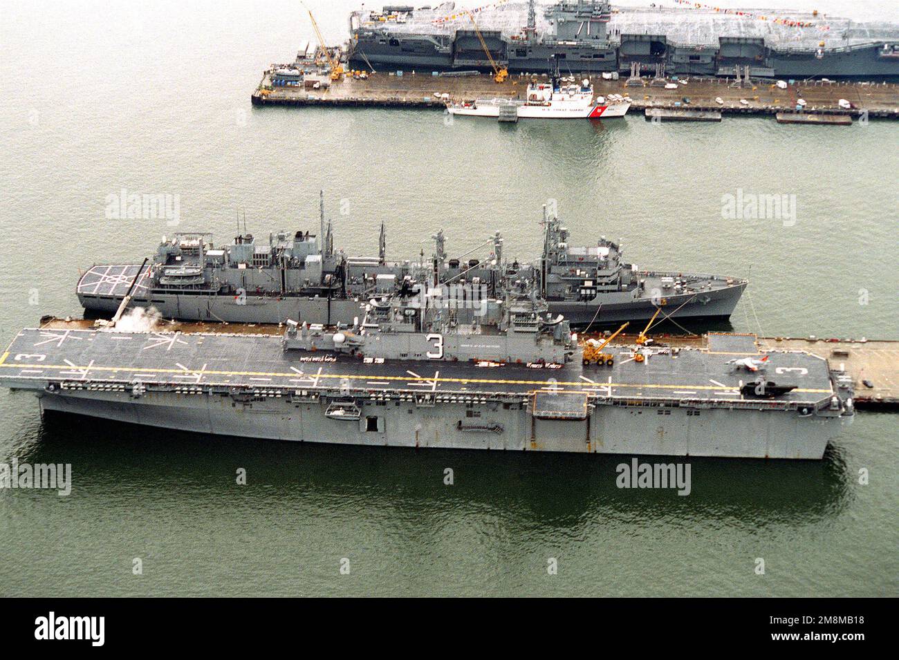Aerial view of the amphibious assault ship USS KEARSARGE (LHD-3) tied up on the south side of ...