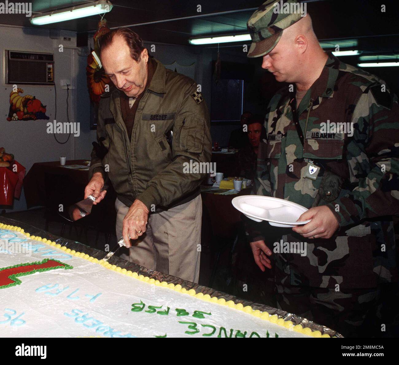 The Honorable Secretary of Defense William Perry cuts the first piece ...