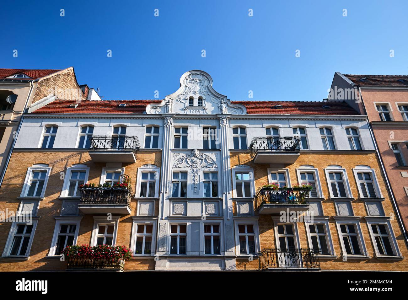 historic red brick tenement house with balcony in the city of Poznan ...