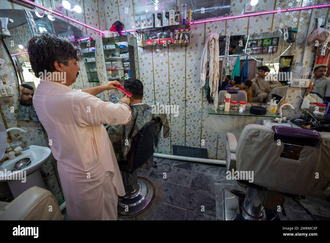 Barber serving a client in his barbershop, Peshawar, Pakistan Stock ...