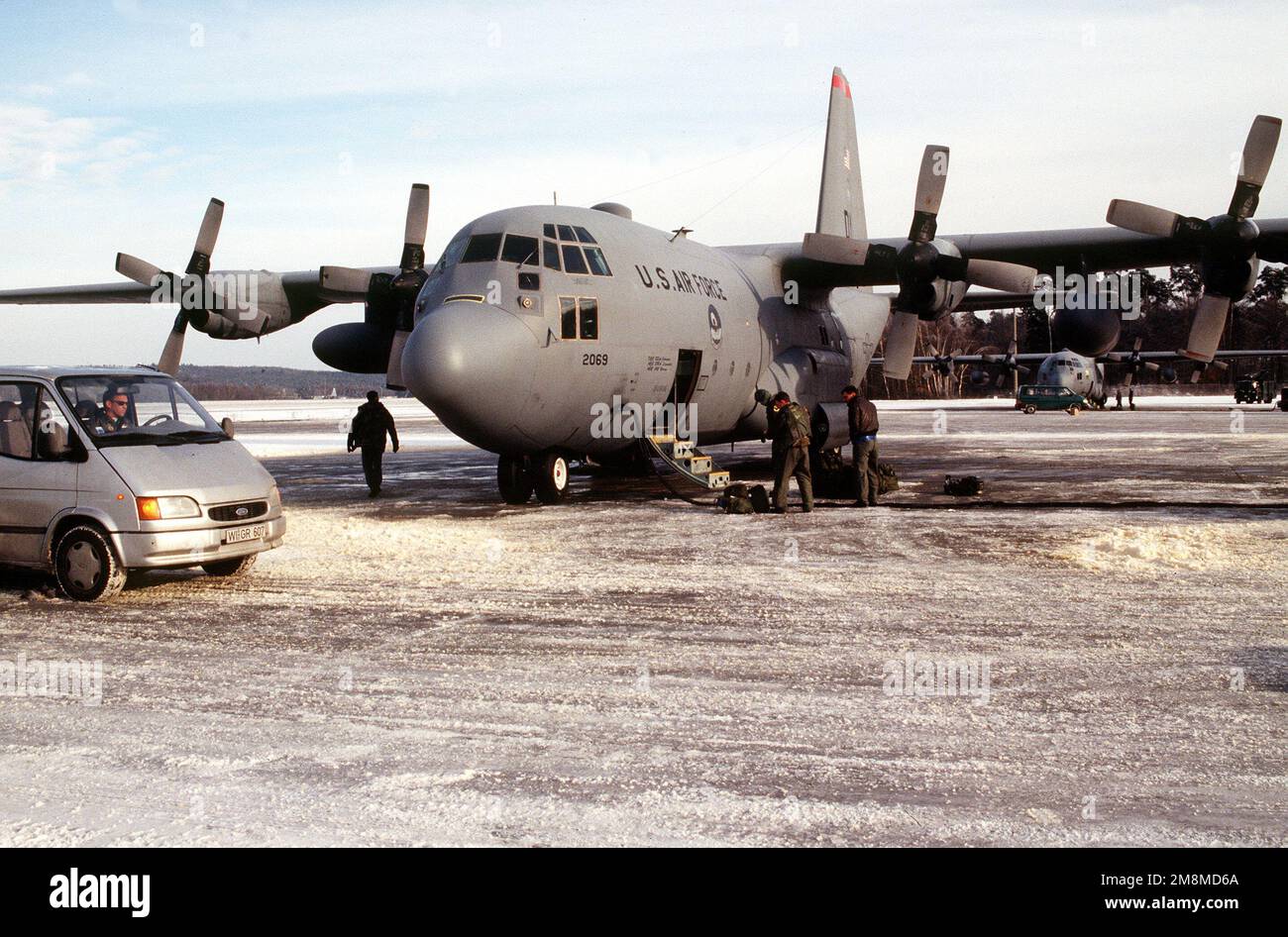 Ground crew prepare a C-130 Hercules to deliver supplies to Tuzla Air ...
