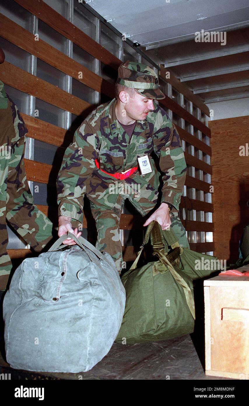 CAPT. Stevens from the 61st Air Base Group loads mobility bags on a ...