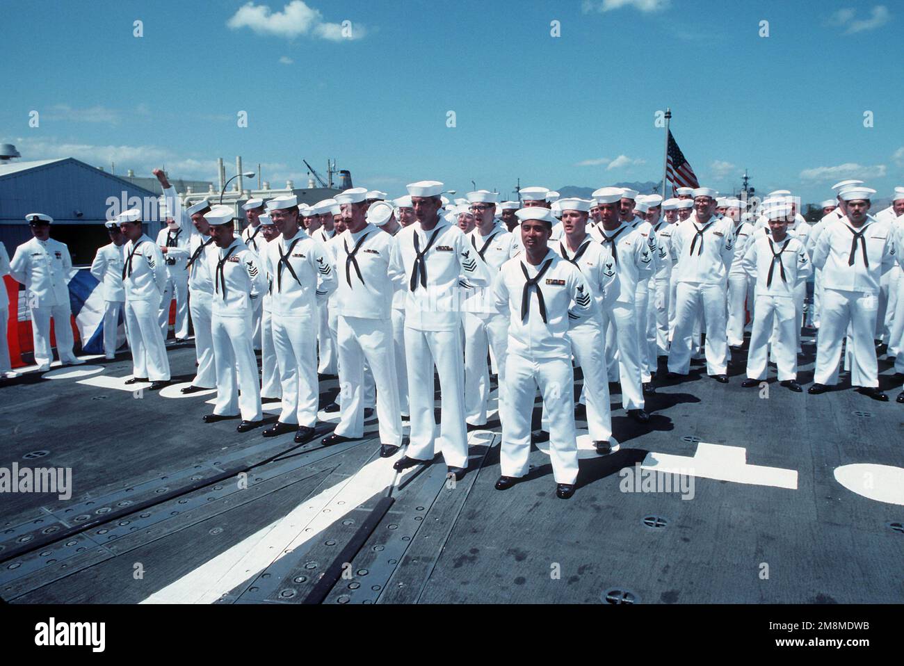 Summer dress whites was the uniform of the day as these sailors stand ...