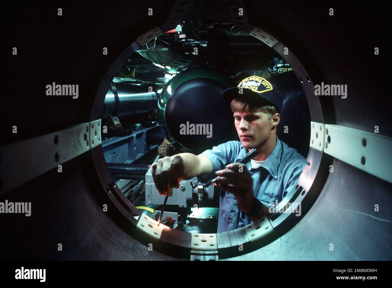 A torpedoman on board the nuclear-powered attack submarine USS Oklahoma ...