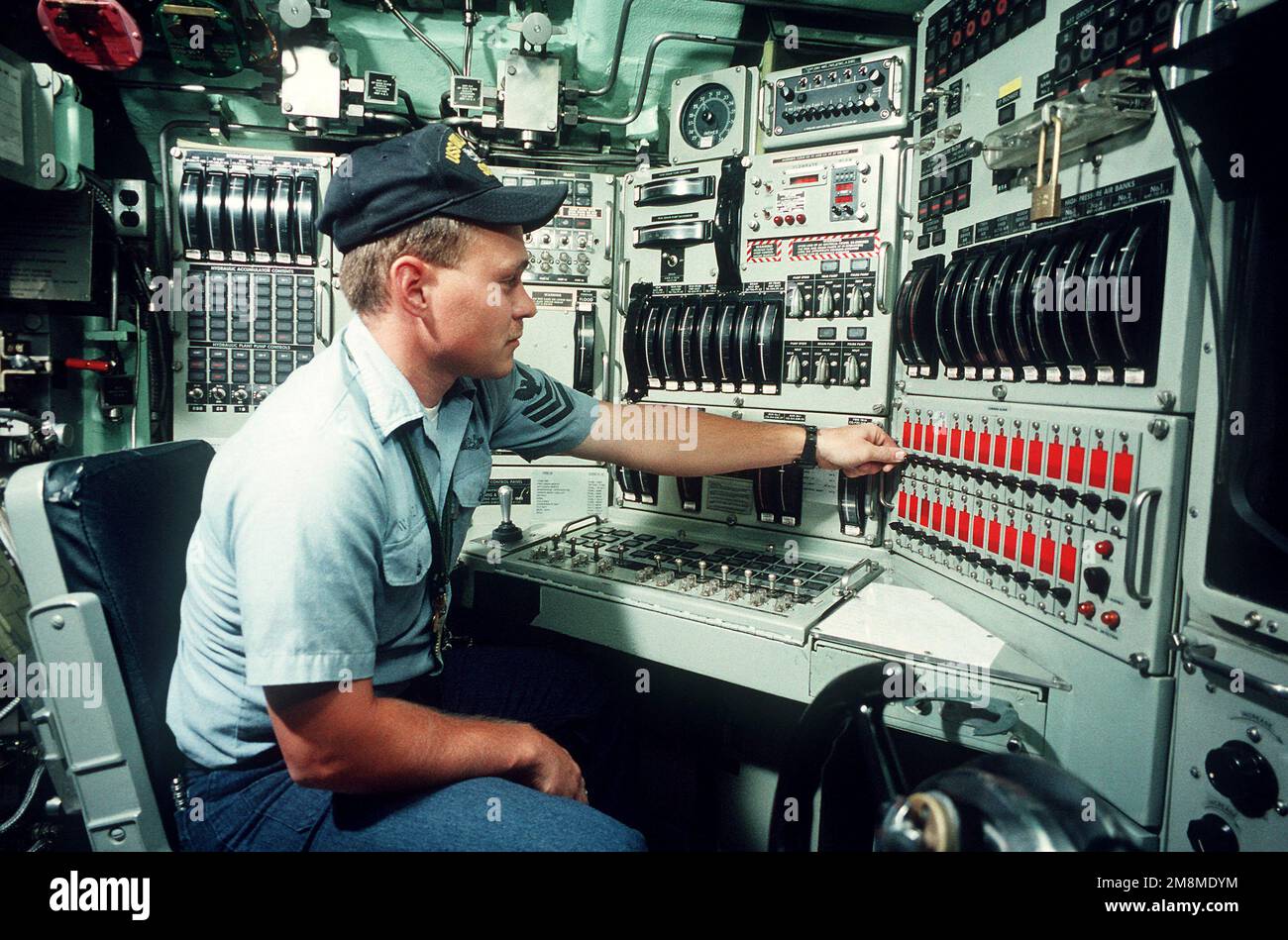 A crewman at the control center console of the nuclear-powered attack ...
