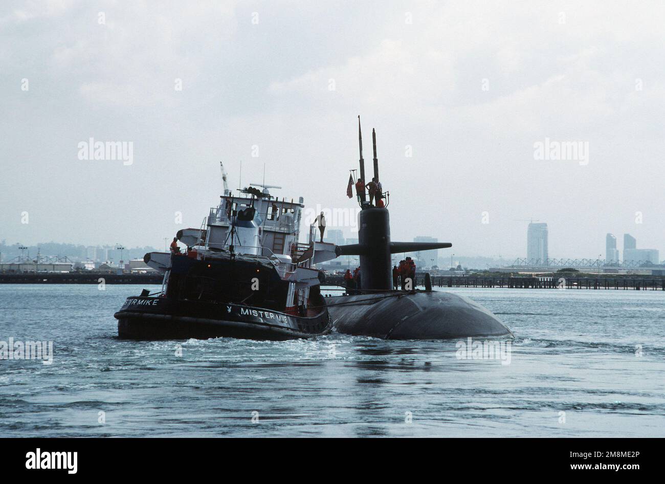 The civilian tugboat Mister Mike mate up alongside the nuclear-powered ...
