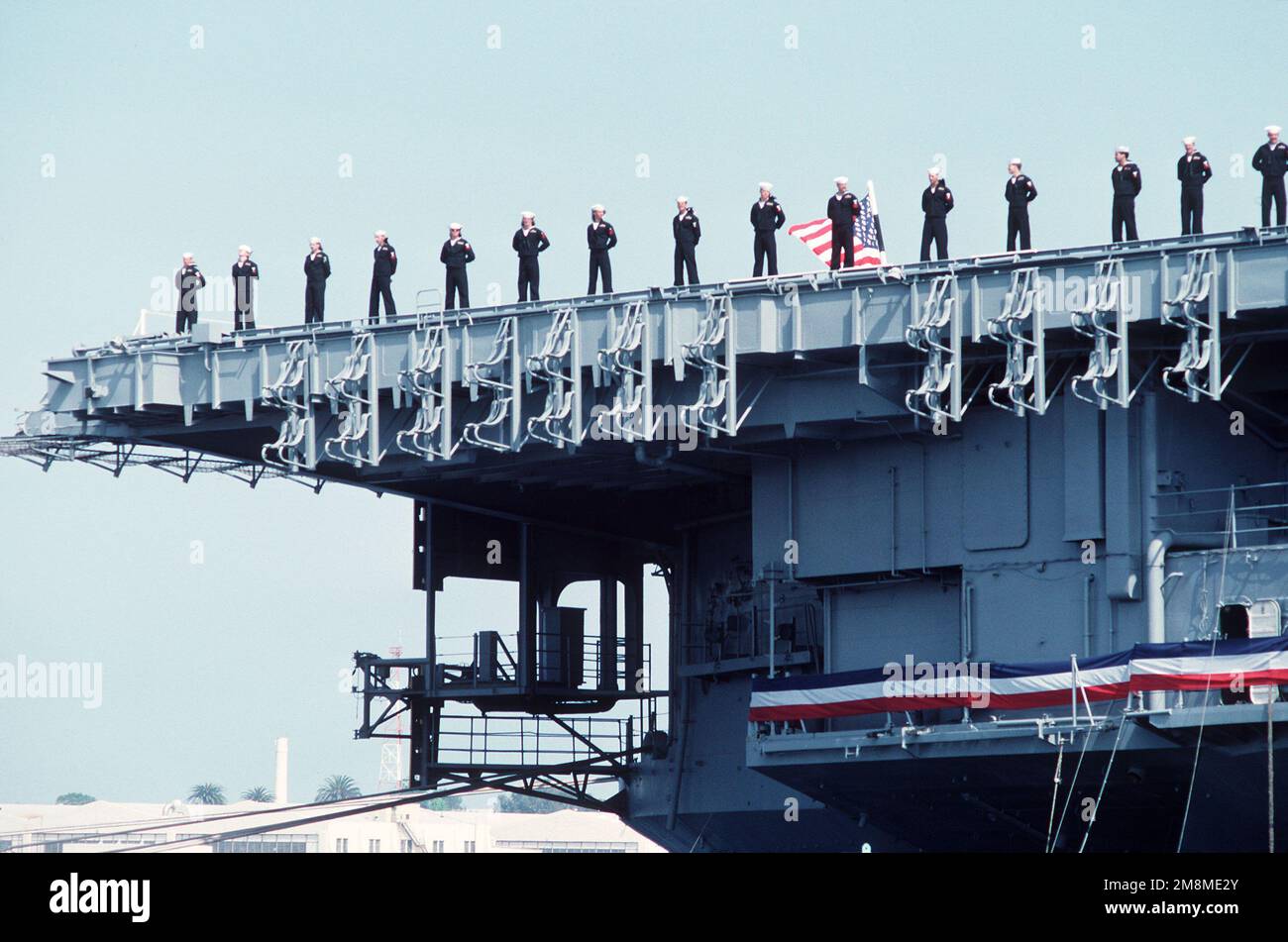 Crewmembers of the aircraft carrier USS Midway (CV-41) man the rail ...
