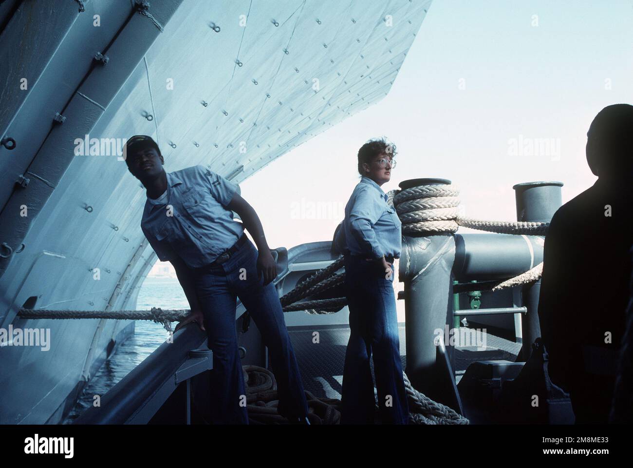 The overhang of a large ships hull dwarfs the large harbor Wenatchee ...