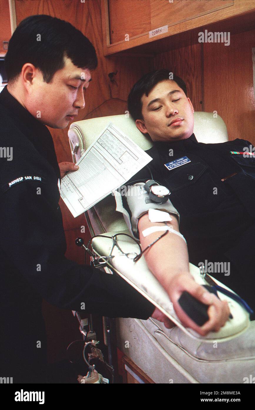 A hospital corpsman demonstrates to Hospital Corpsman 2nd Class (HM2) T ...