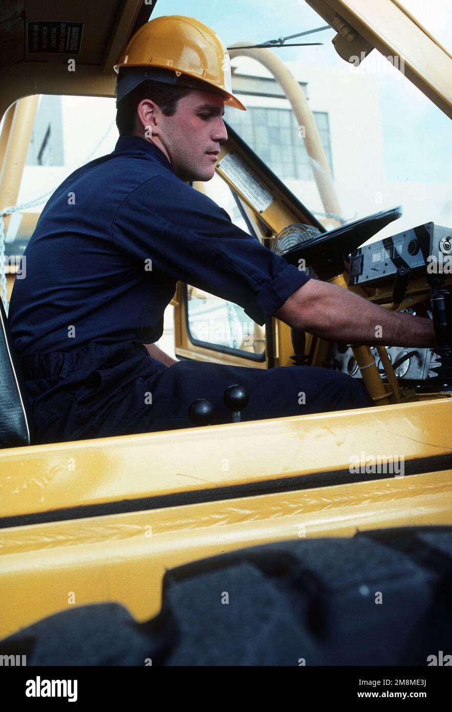 A Navy forklift operator loading recyclable materials for sorting at ...