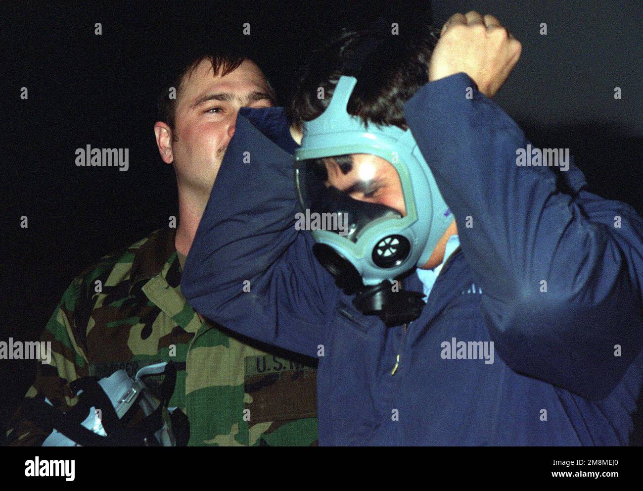 US Navy Utilityman 2nd Class Lonnie Cosper (Left), supervises the ...