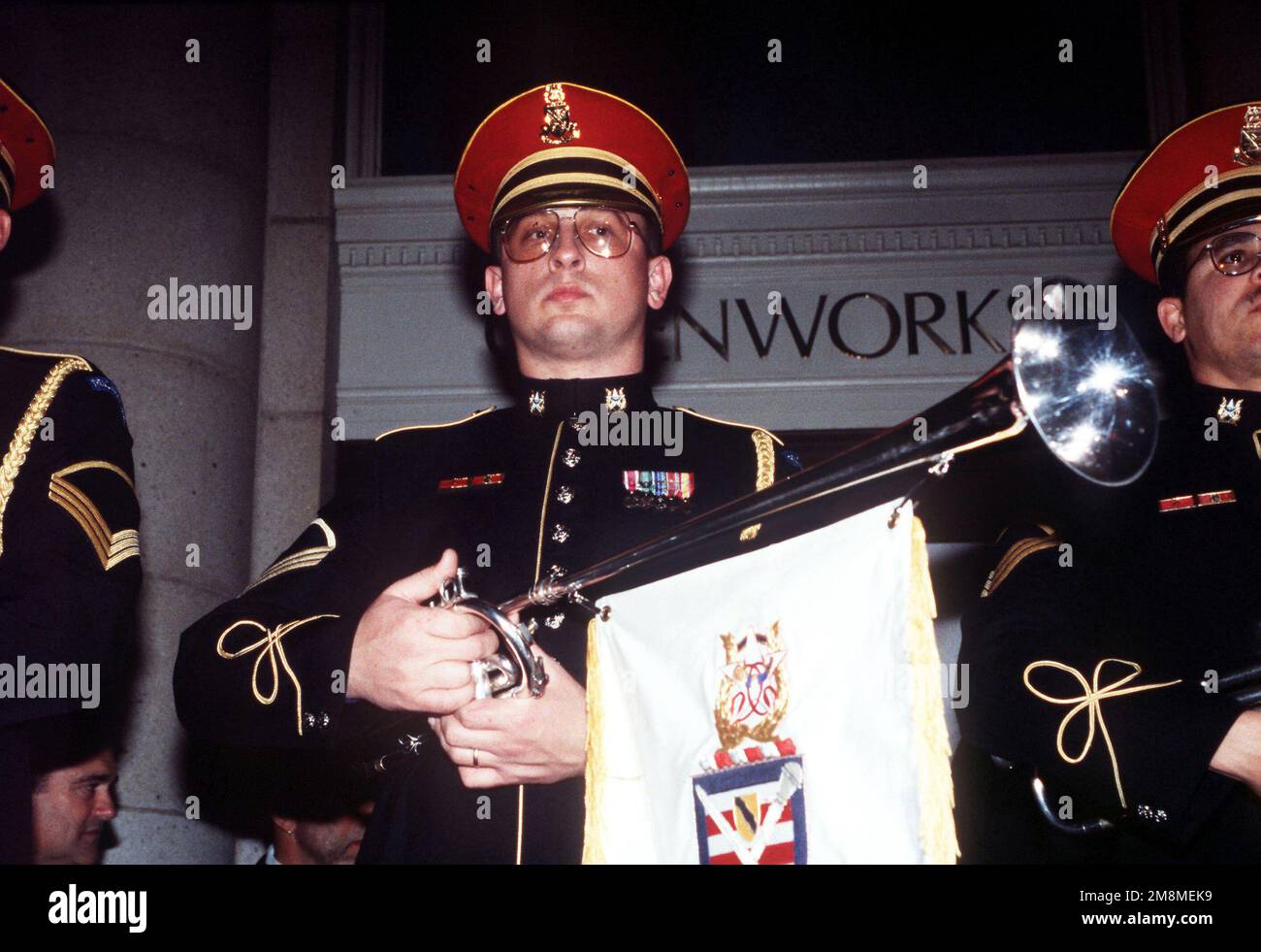 A member of the US Army Herald Trumpets awaits the arrival of the ...