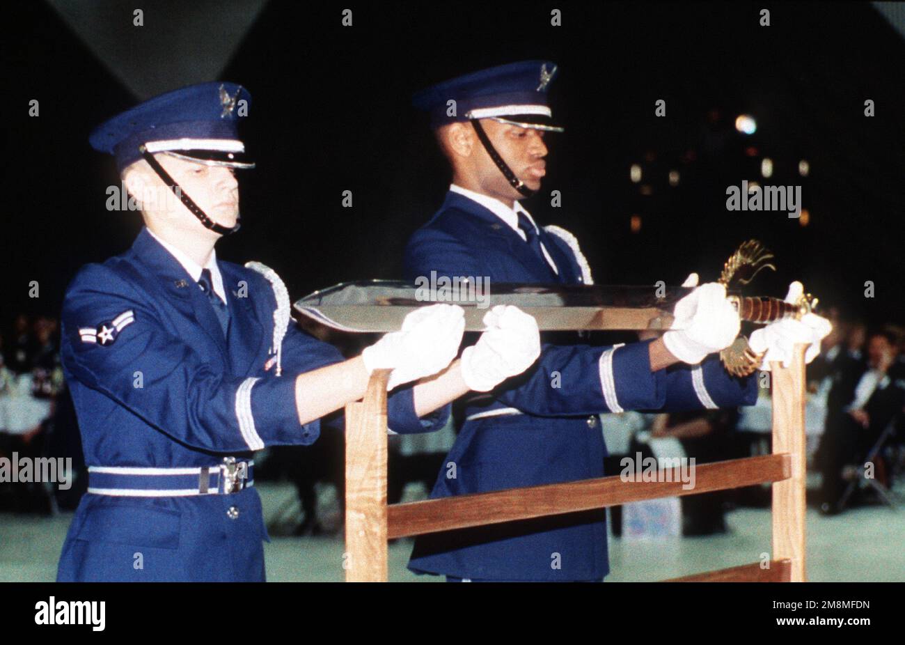 Honor Guard members place the symbolic sword on the stand in front of ...