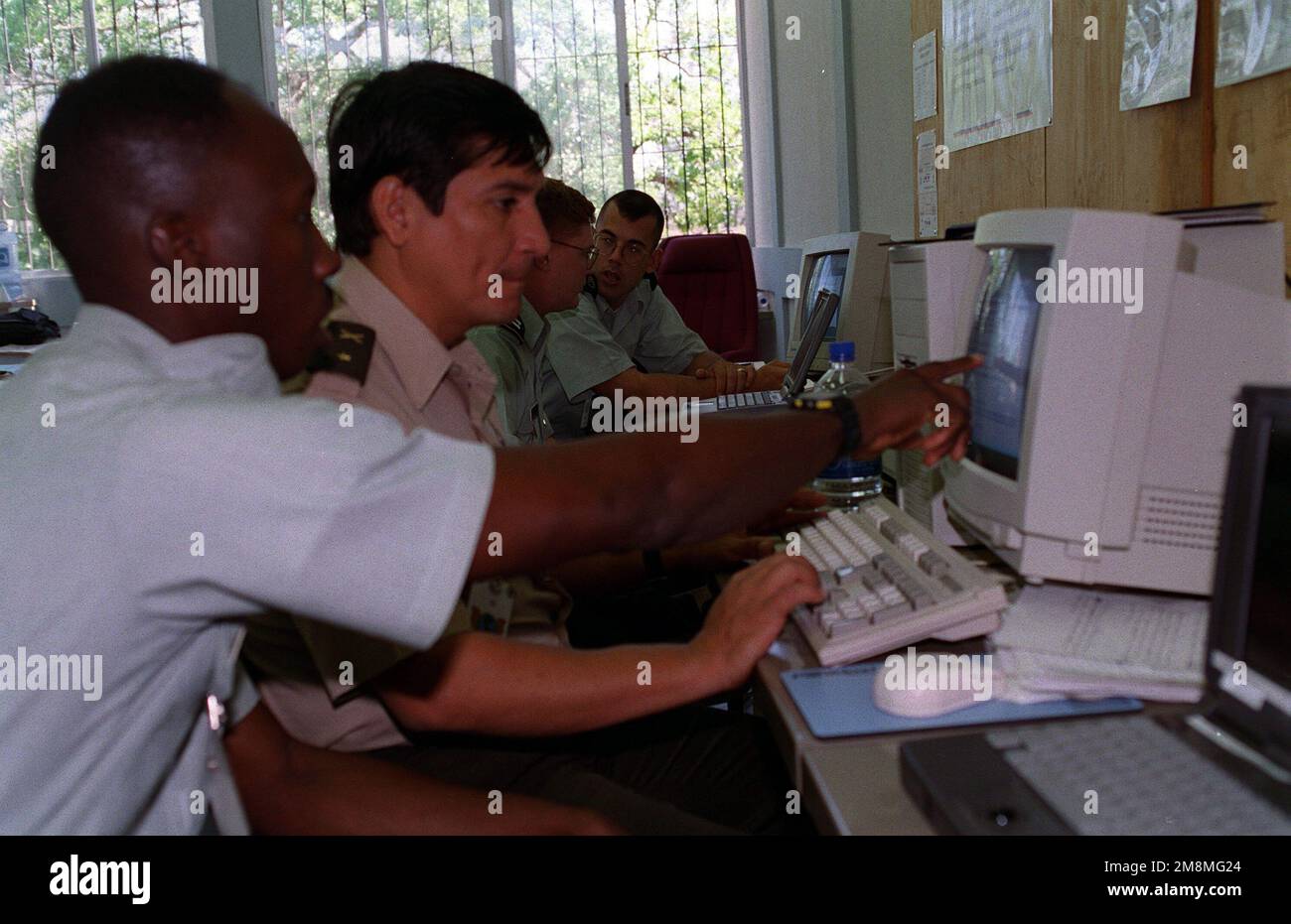 MAJ. Alvarado, of the El Salvador Army, receives pointers on computer ...