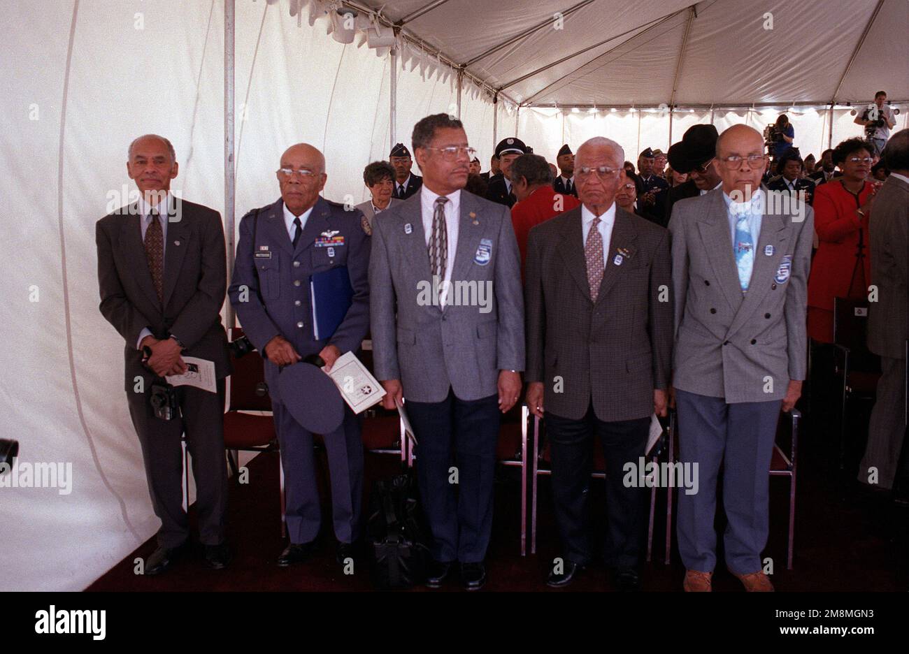 Original Tuskegee Airmen stand at attention during the dedication of a ...