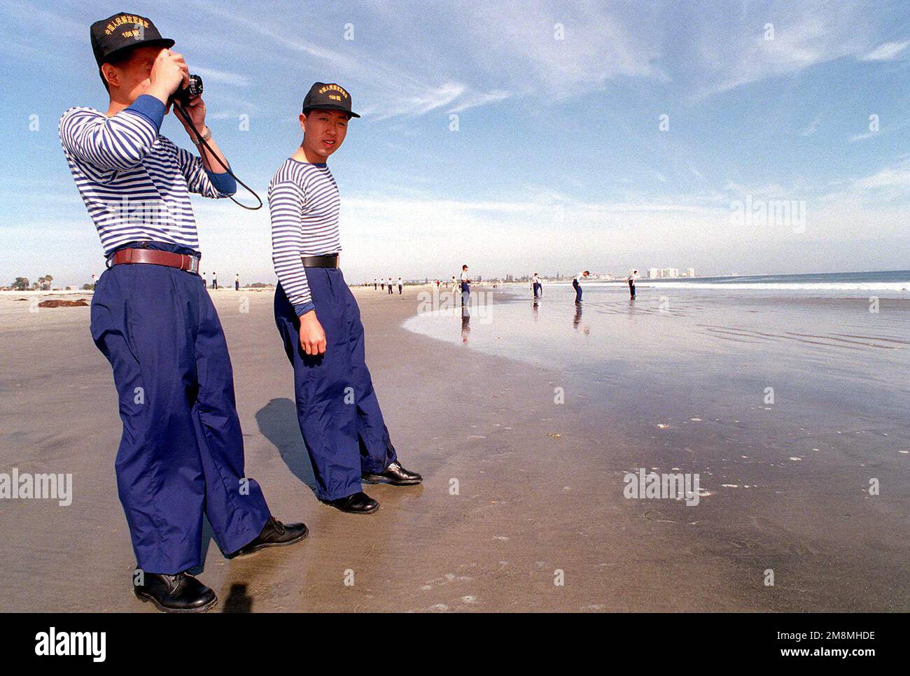 Chinese sailors enjoy the view from the beach at Naval Air Station ...