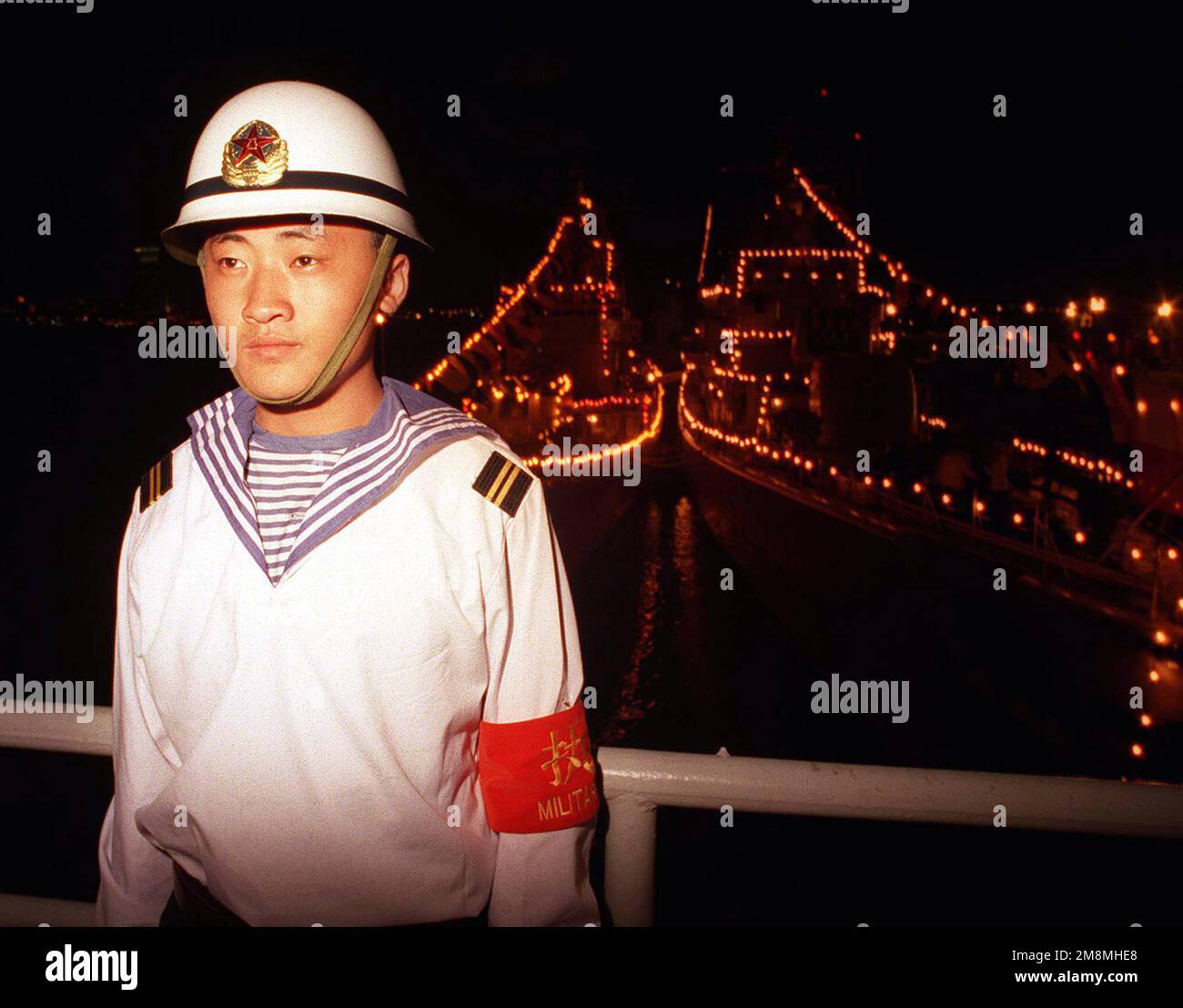 A Chinese Sailor stands watch on the supply ship NANCANG (AO 953) as ...