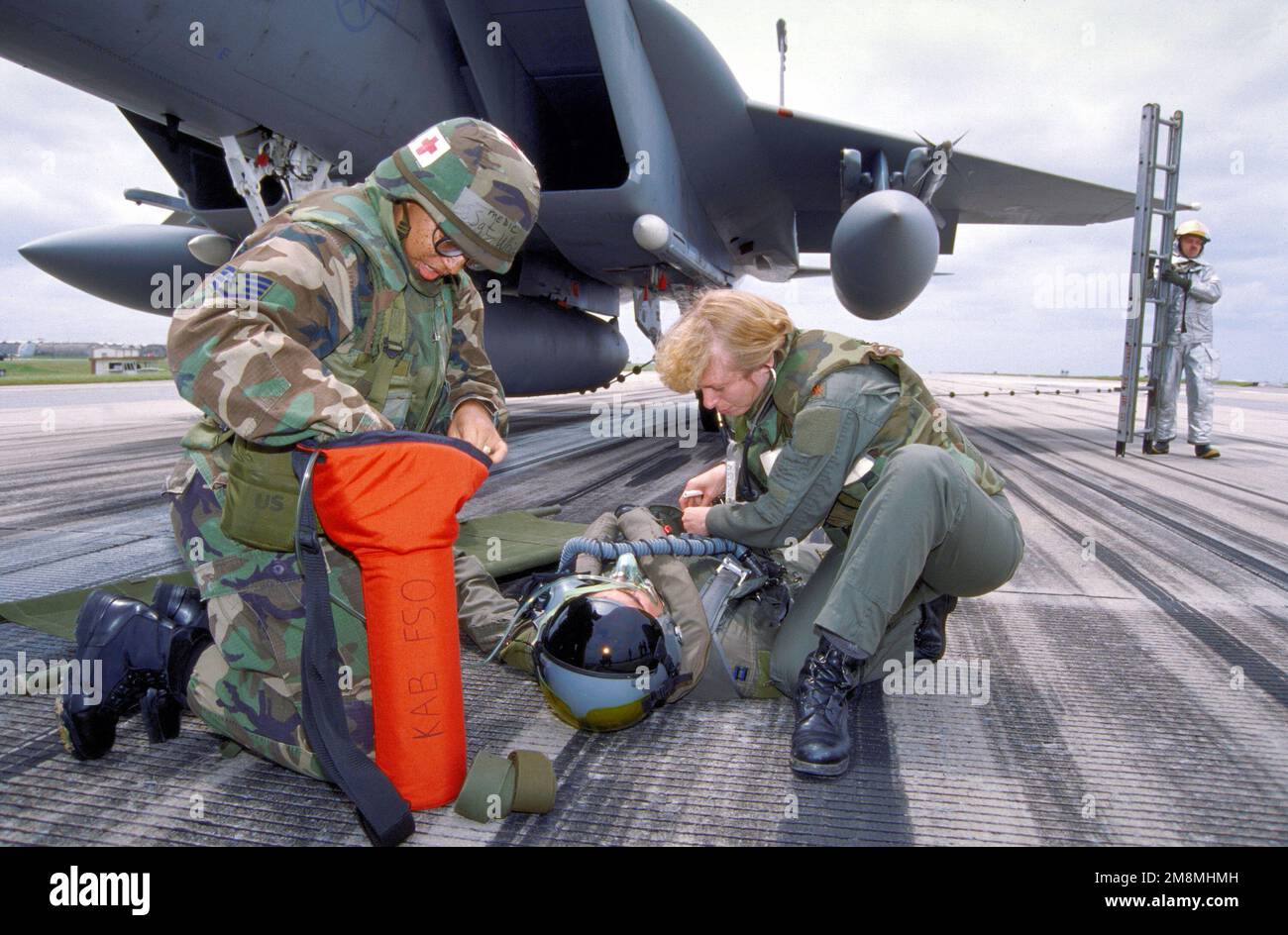Two members of the 18th Medical Group, Kadena AB, Japan, assist an ...