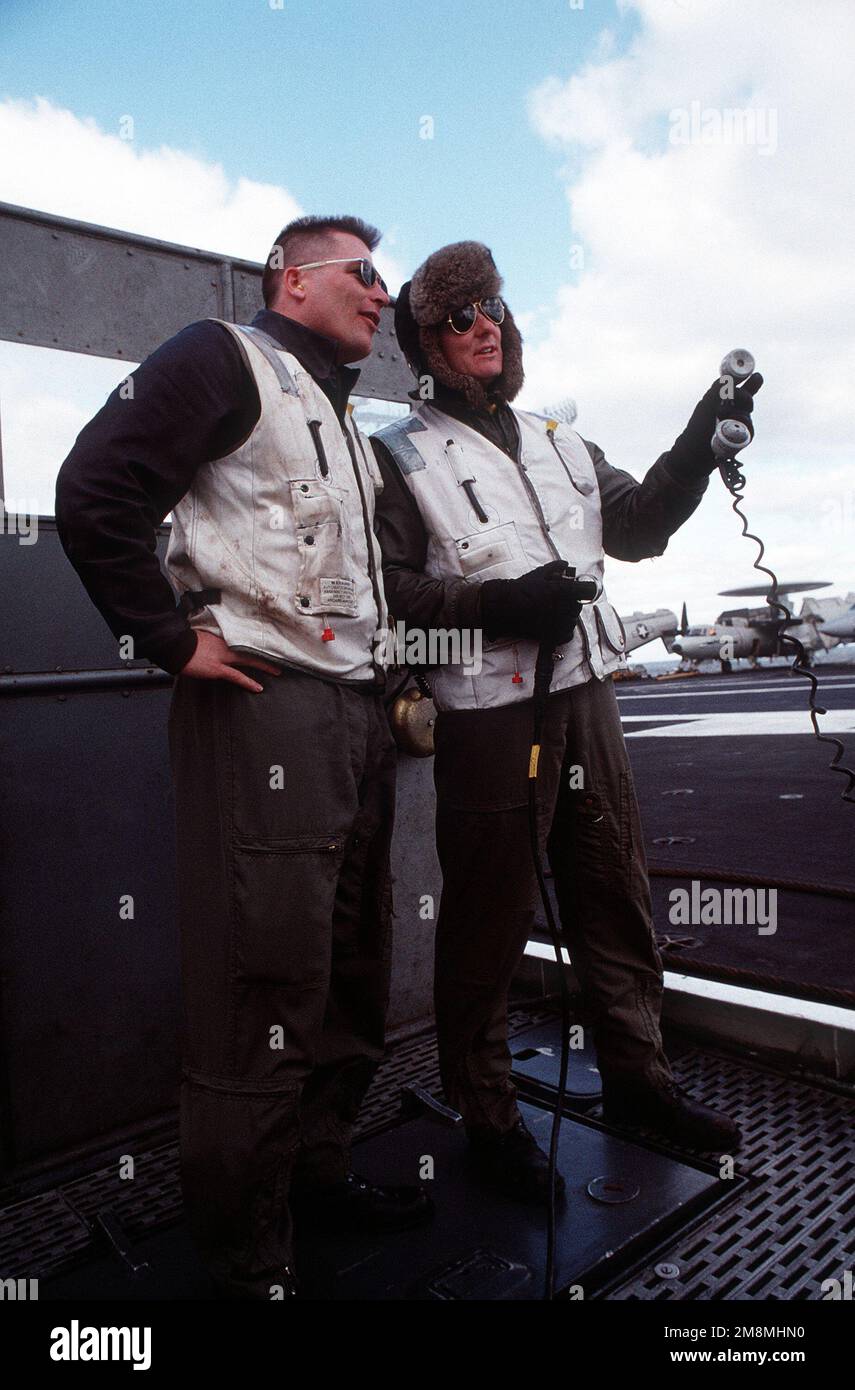 CPT Mike G. "Hatchet" Harmon shouts over the racket of landing jets to ...
