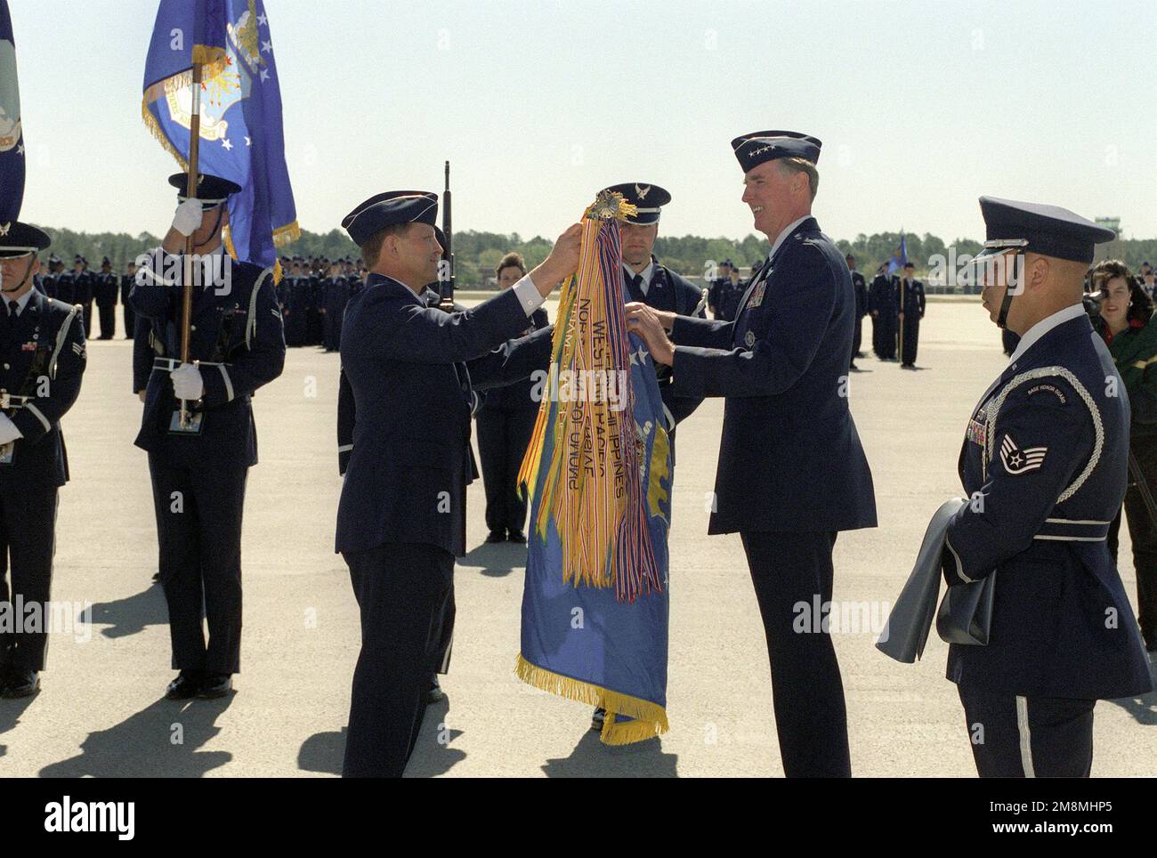 GEN. Walter Kross (Right) Commander, Air Mobility Command assists ...