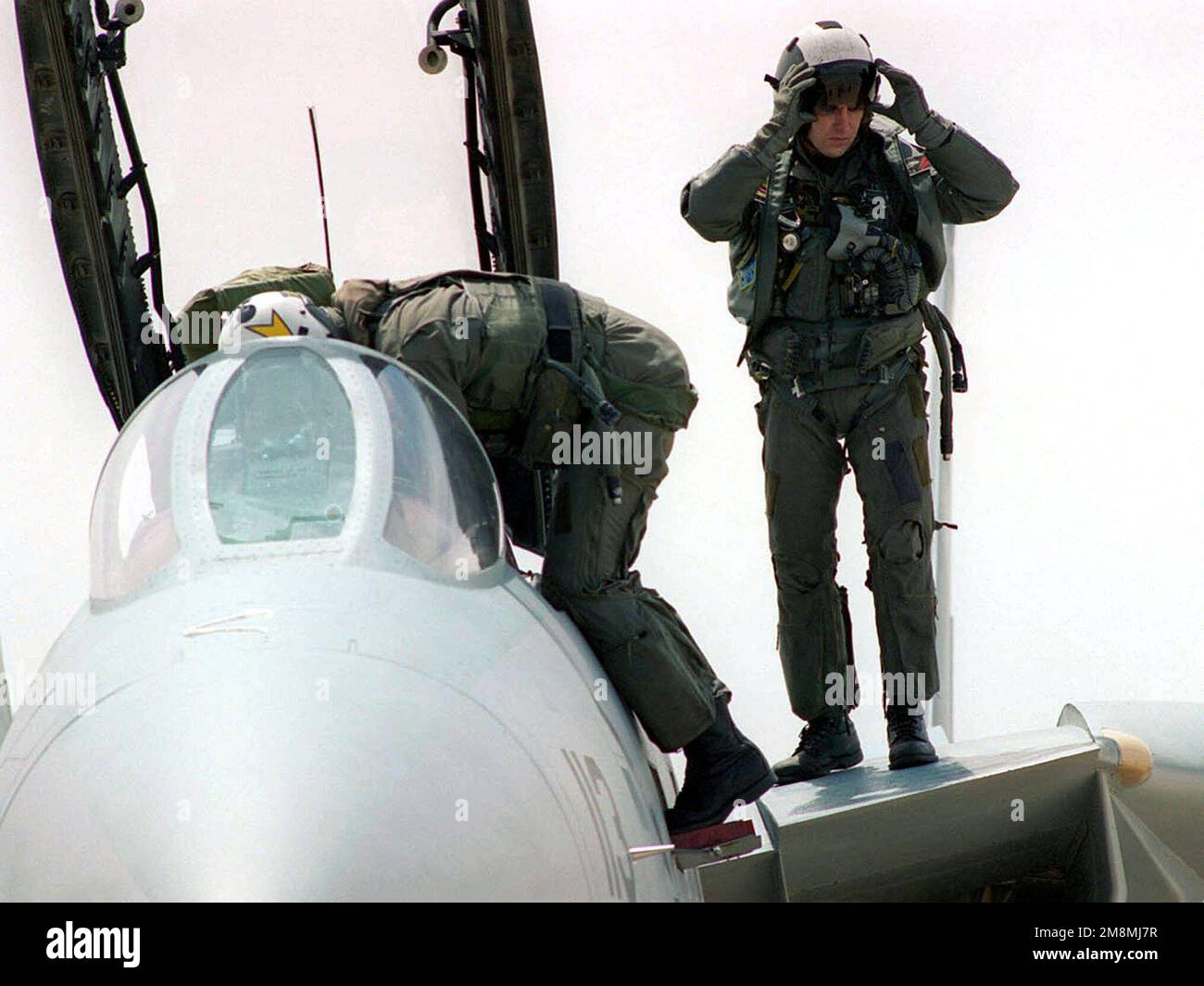 A U.S. Navy F-14 Tomcat pilot and radar intercept officer get out of ...