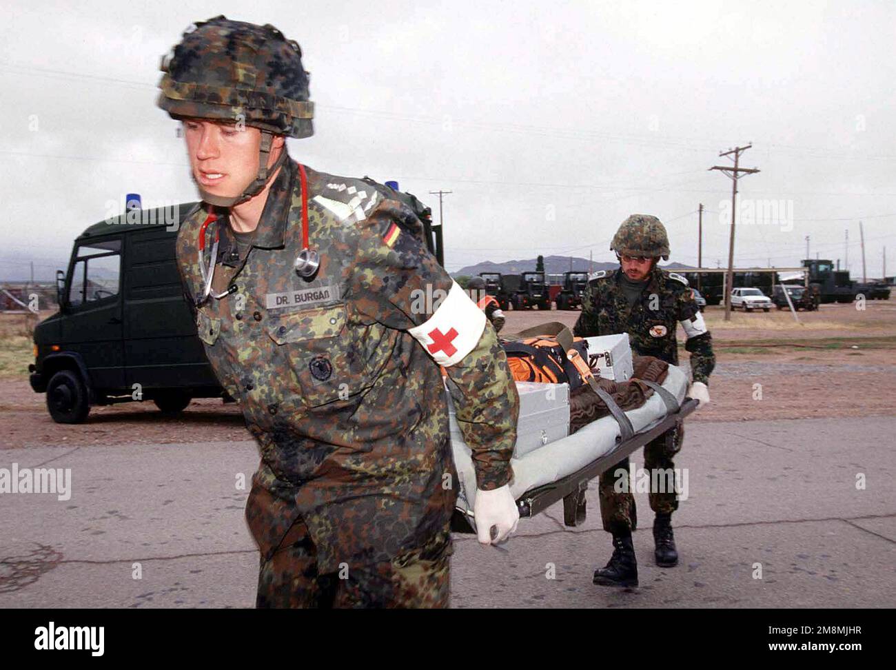 Medical personnel, from the German Air Froce Rescue center #1, carry a ...