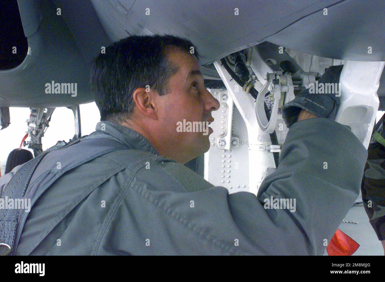 On the flight line beneath his F-15, pilot MAJ Clark Burtch, does his ...