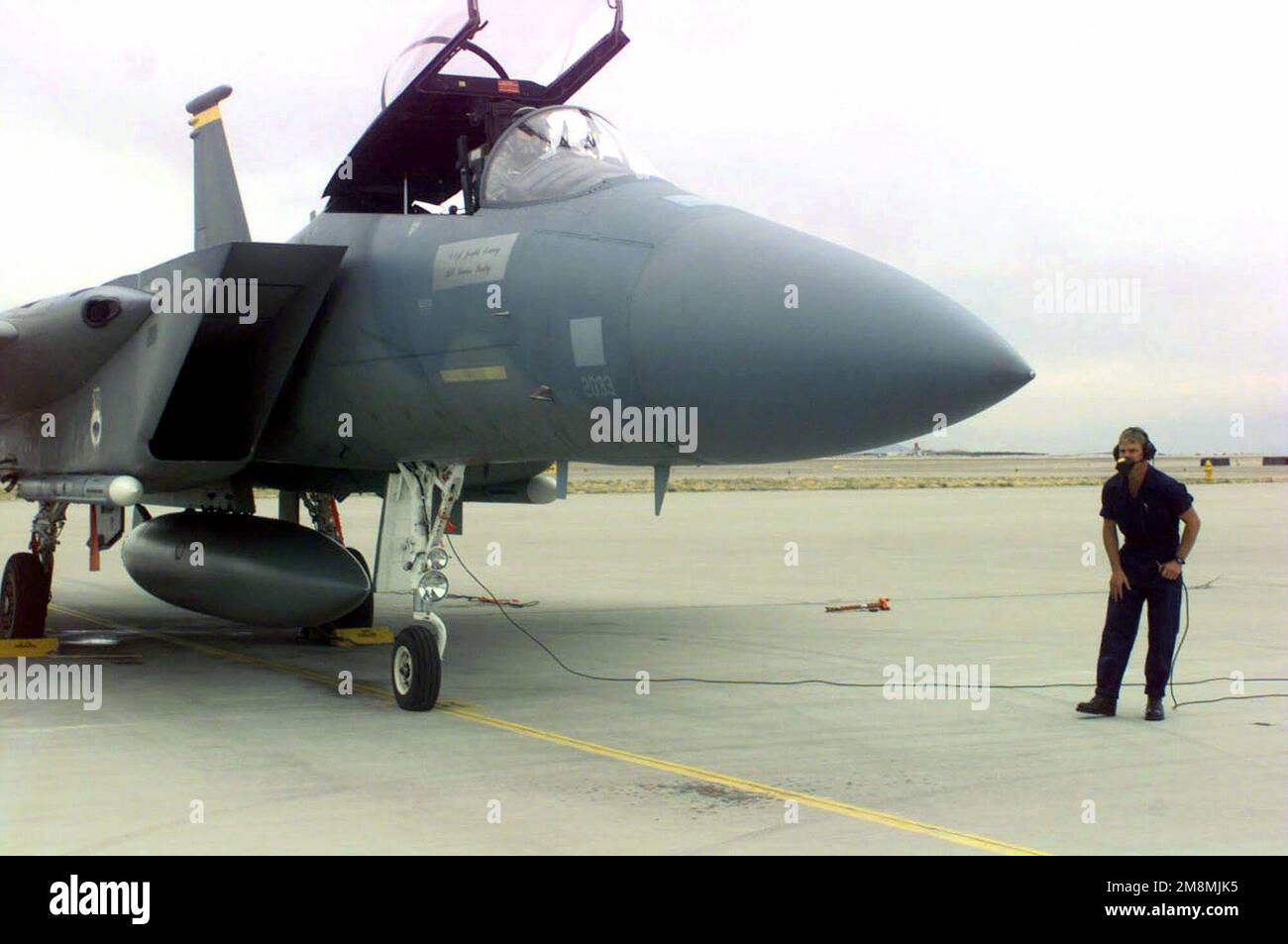On the flight line A1C Kurt Guidry, crew chief, talks with MAJ Clark ...