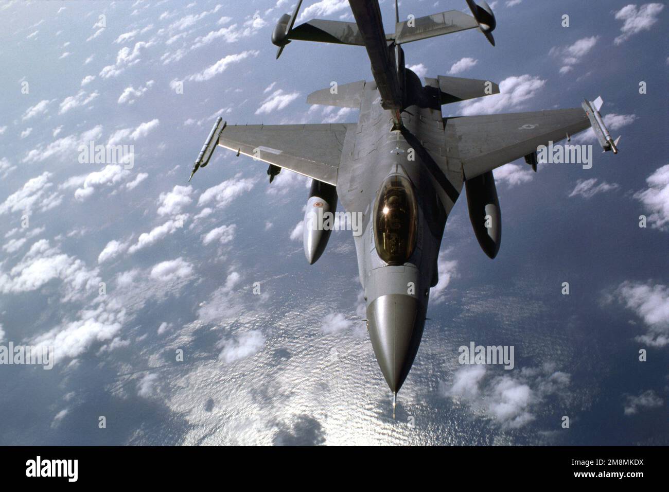A USAF F-16 Falcon aircraft connects to the refueling probe of a KC-10 ...