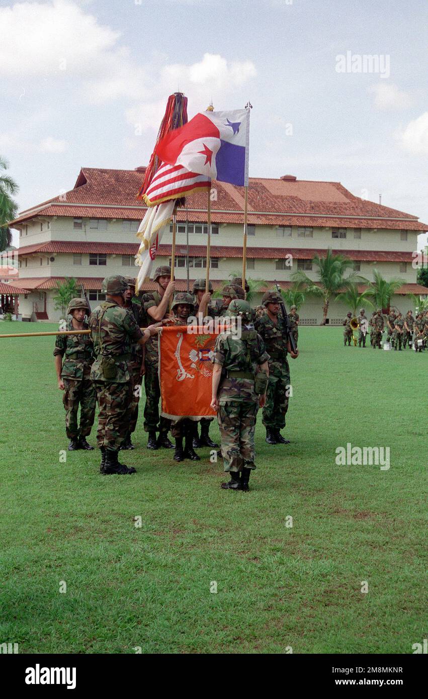 CSM Barbara A. White rolls up the flag during the inactivation ceremony ...