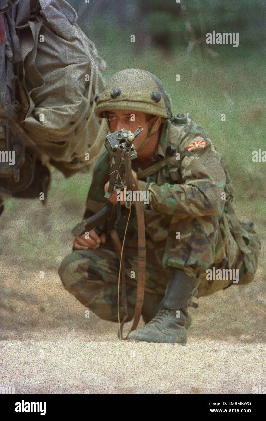 A Partnership For Peace soldier takes cover behind a High-Mobility ...