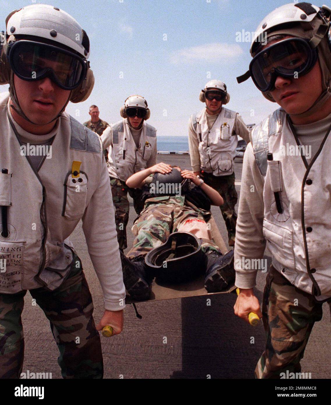 Marines from the USS PELELIU (LHA-5) Combat Cargo Department, lift a ...