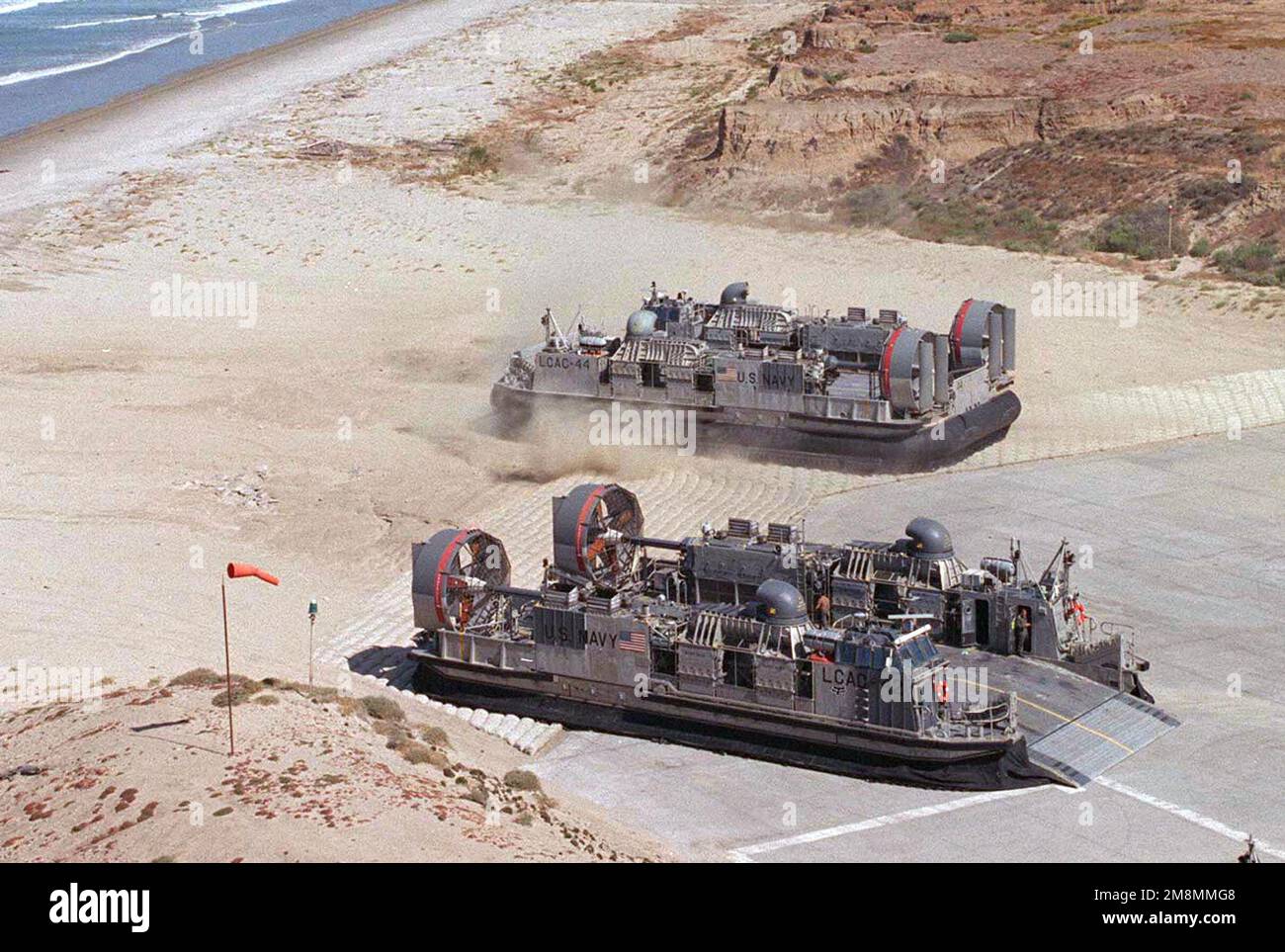 Two air cushioned landing craft (LCAC) from Assault Craft Unit Five ...