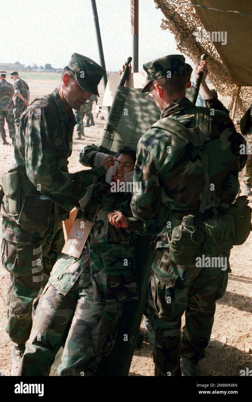 A simulated casualty of war victim is brought into the Field Hospital ...