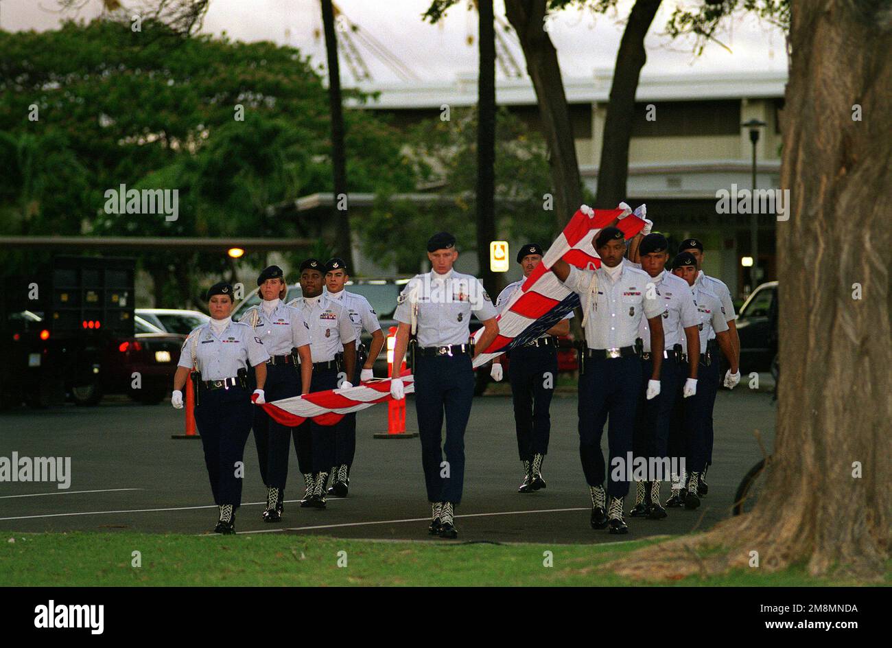 Members of the 15th Wing Honor Guard prepare to execute the pass and ...