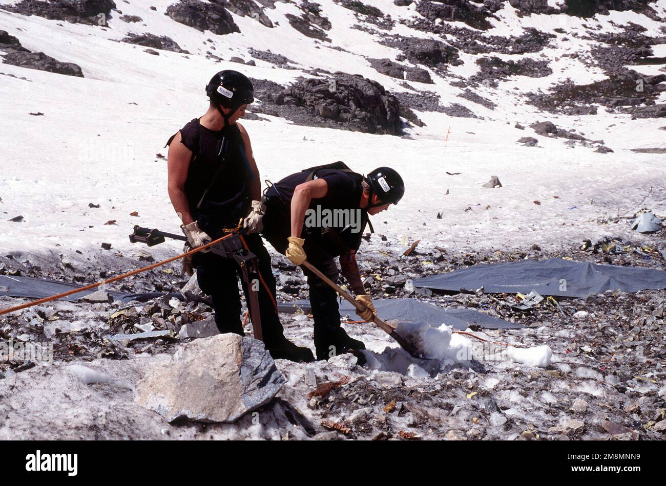 Members of the Explosive Ordnance Disposal team sweep the A-10 debris ...