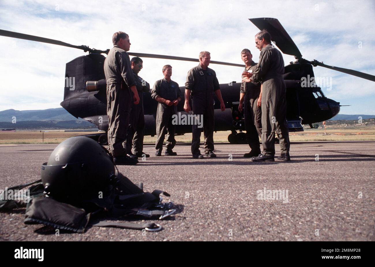 On the tarmac, with their helicopter behind them, CH-47 helicopter crew ...