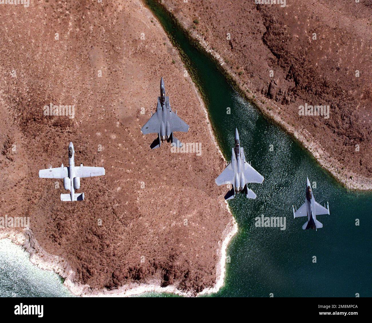 An A-10, F-15E, F-15C and F-16D all from Nellis AFB, Nev., fly over ...