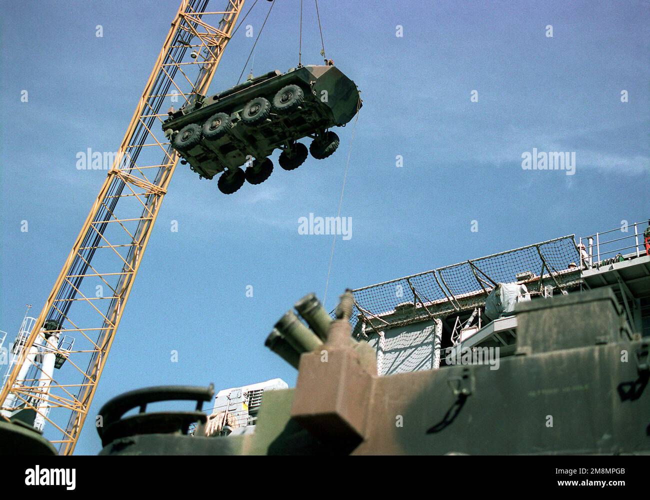 A port heavy-lift crane lifts a Light Armored Vehicle-25 (LAV-25) up ...