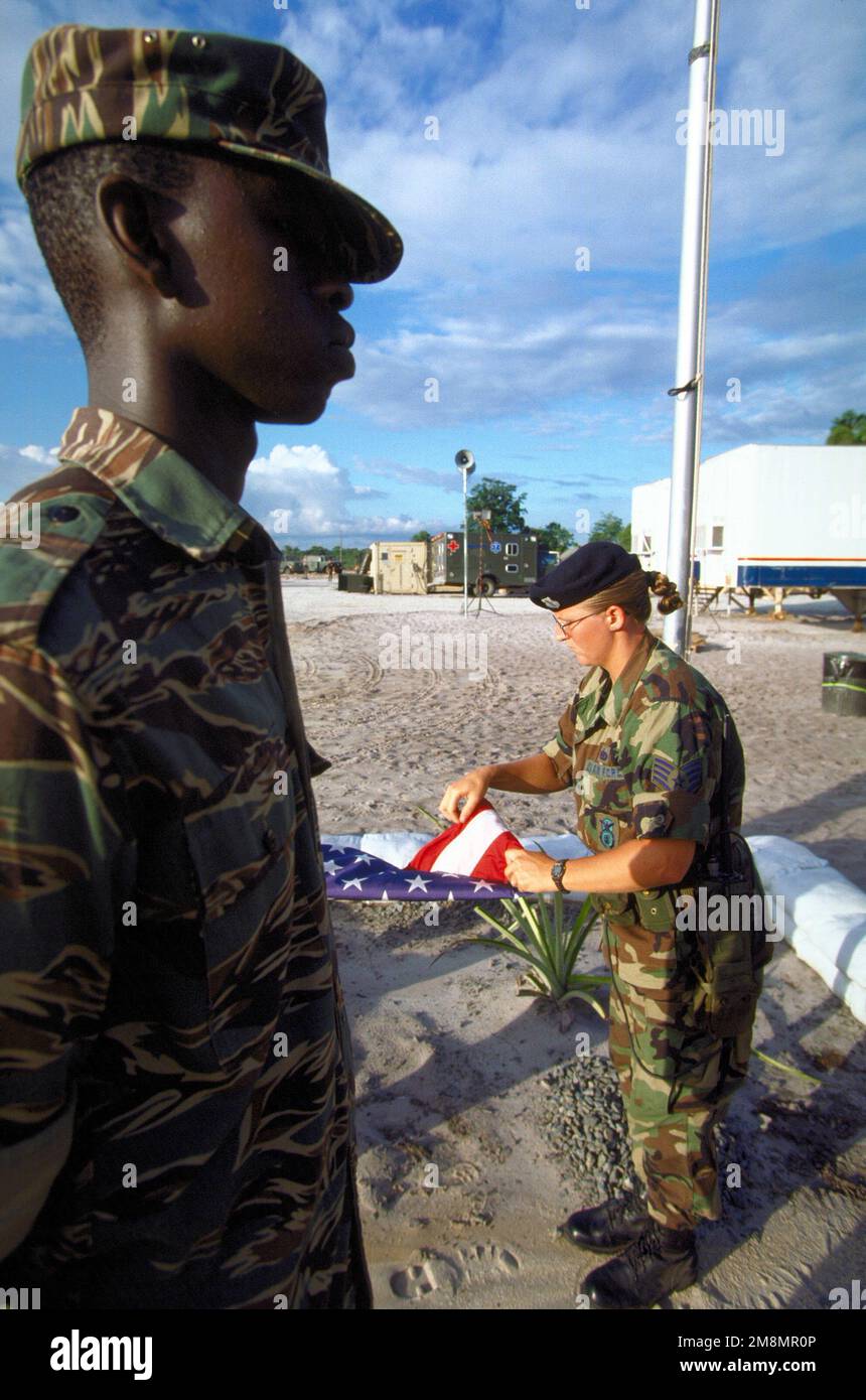 A Guyana Defense Force specialist stands by as STAFF SGT. Denise Watson ...