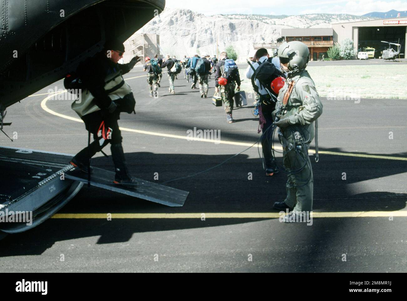 Members of the A-10 recovery team exit the CH-47 helicopter after ...